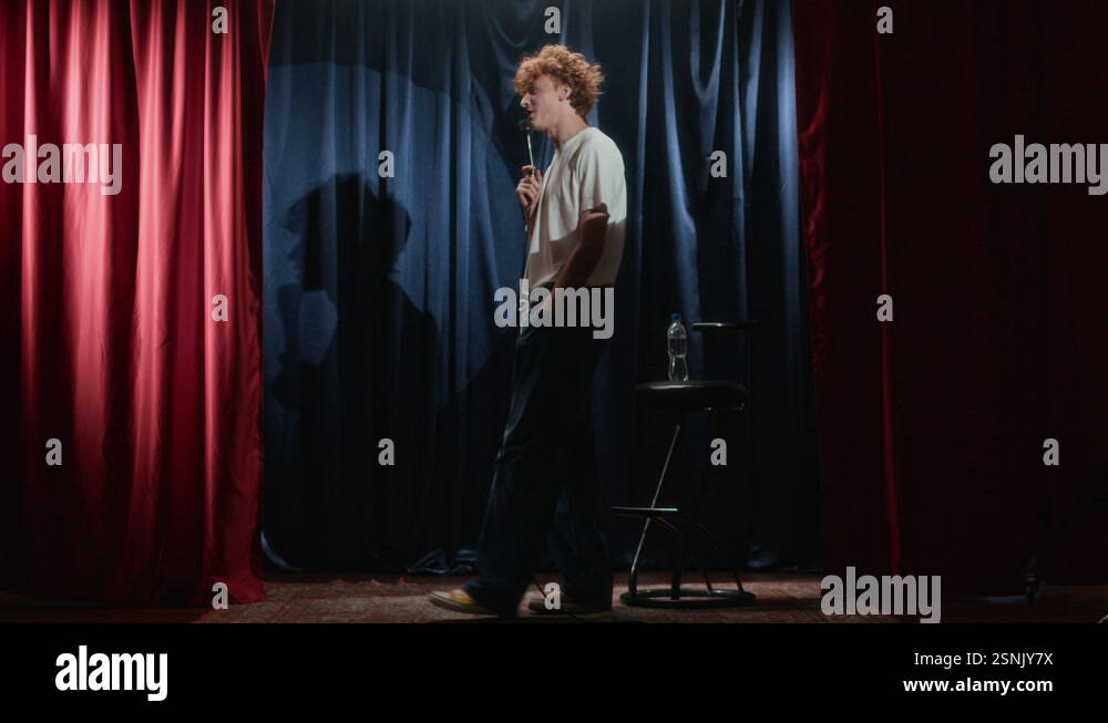 Gen Z Comedian Casually Walking on Small Stage with Microphone and ...