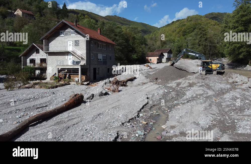 Flooded houses and properties after the floods. Large deposits of rocks ...