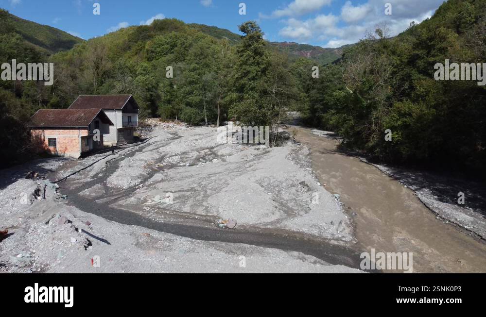 Flooded houses and properties after the floods. Large deposits of rocks ...