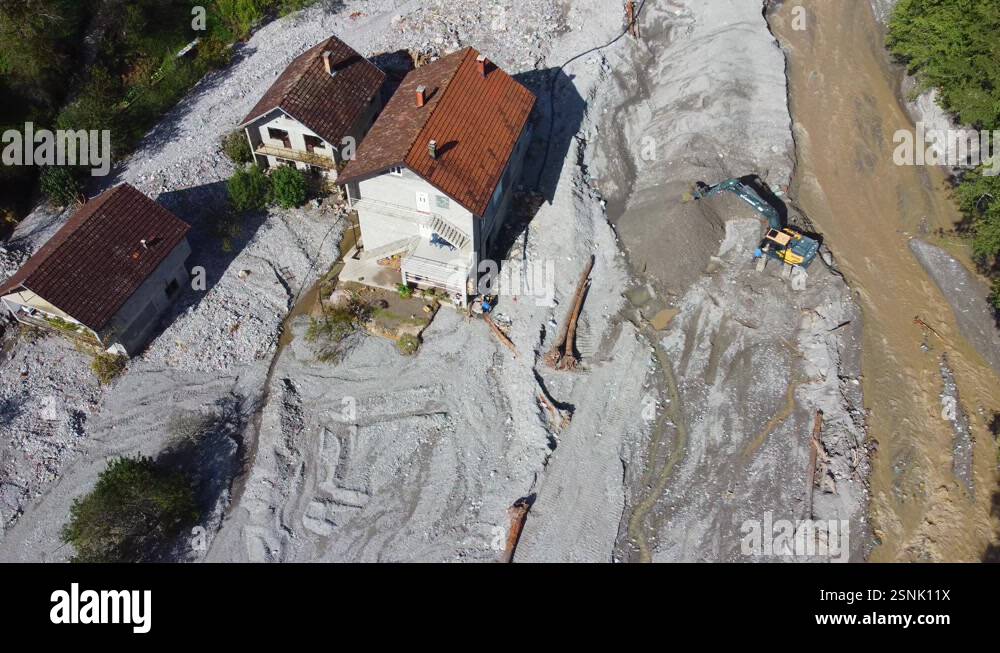 Flooded houses and properties after the floods. Large deposits of rocks ...