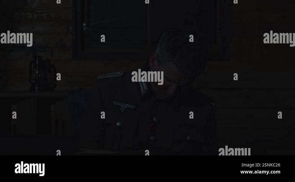 An unconscious and wounded German WW2 officer slowly wakes up and looks ...