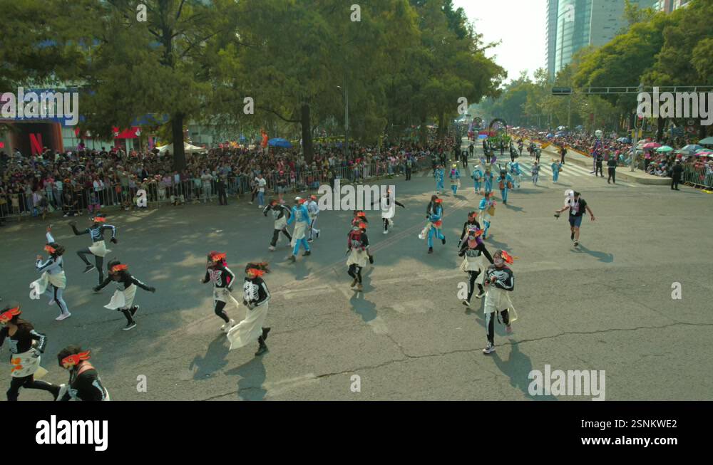 Dolly out tracking of a group of people dressed as skeletons in the ...