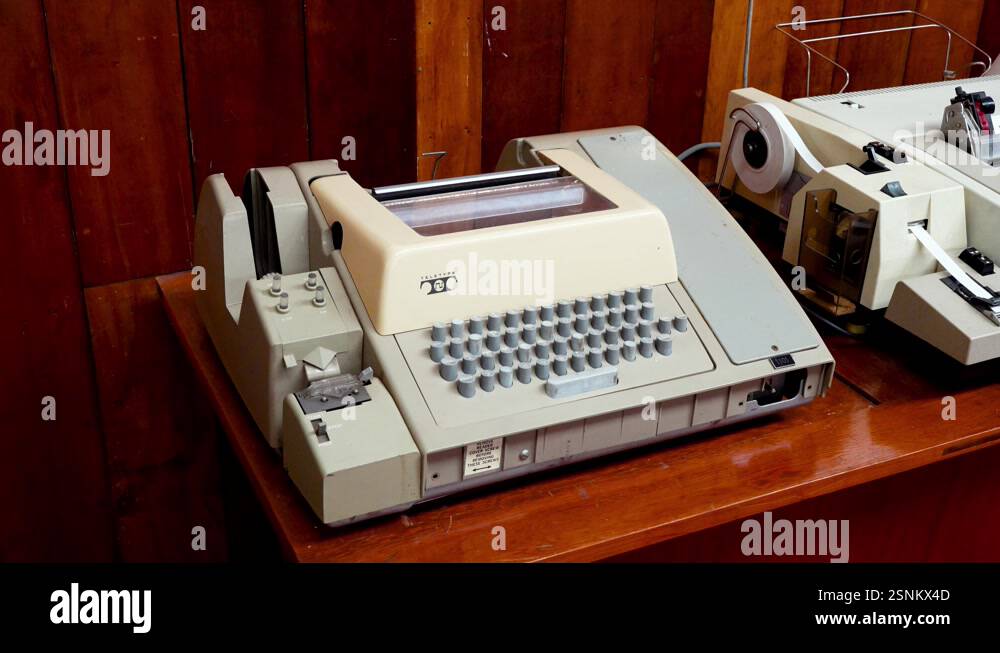 Vintage Teletype teleprinter typewriter model 33 on display on desk Stock Video Footage - Alamy