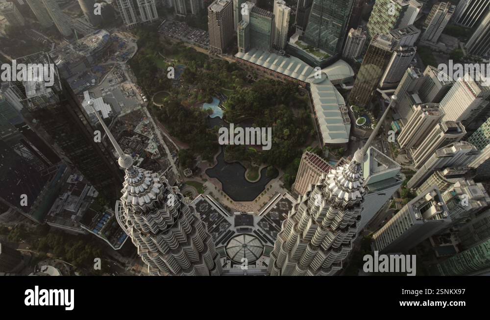 Top-down view of Kuala Lumpur’s iconic towers, transitioning to a ...