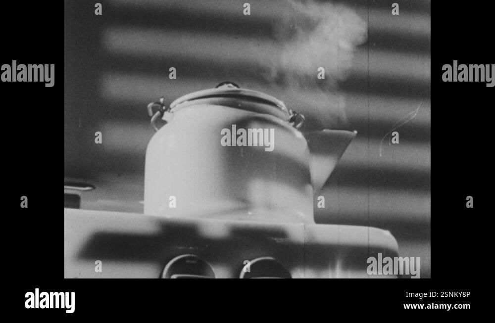 1950s: Steam blows from train engine and tea kettle. Train drives along ...