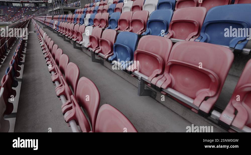 Empty stands in a modern football stadium with red, blue, and white ...