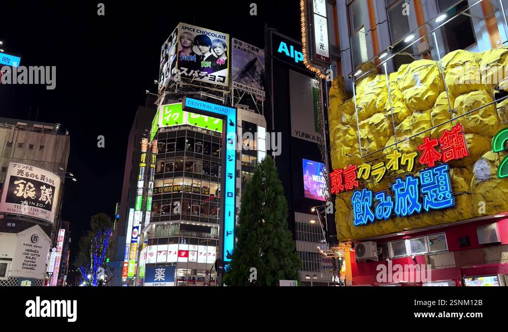 Colorful Neon Lights Illuminate Bustling Shinjuku Street at Night in Tokyo Stock Video Footage ...