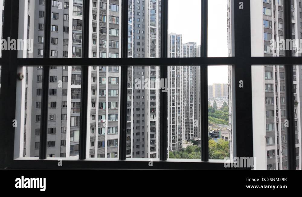 Looking through a balcony window with metal bars from an apartment ...