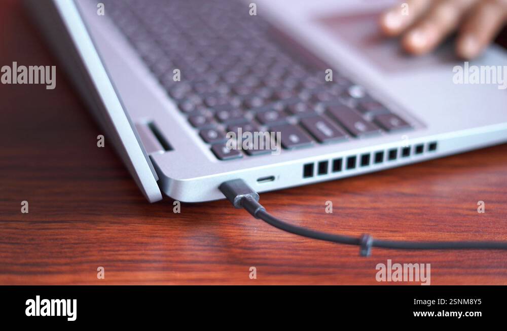 laptop charging wire connect on the table. video footage. 4k Stock ...