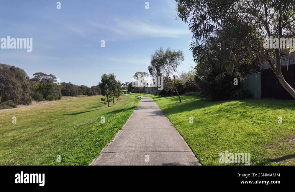 Walking backward of a concrete footpath at Werribee River Trail Stock ...