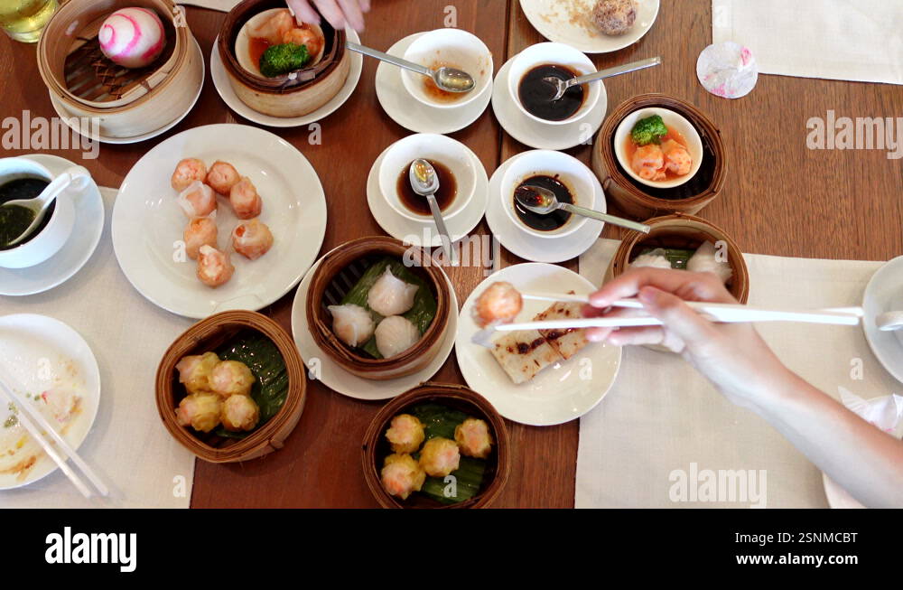 Eating Chinese dim sum from top view Asian restaurant hand chopsticks ...