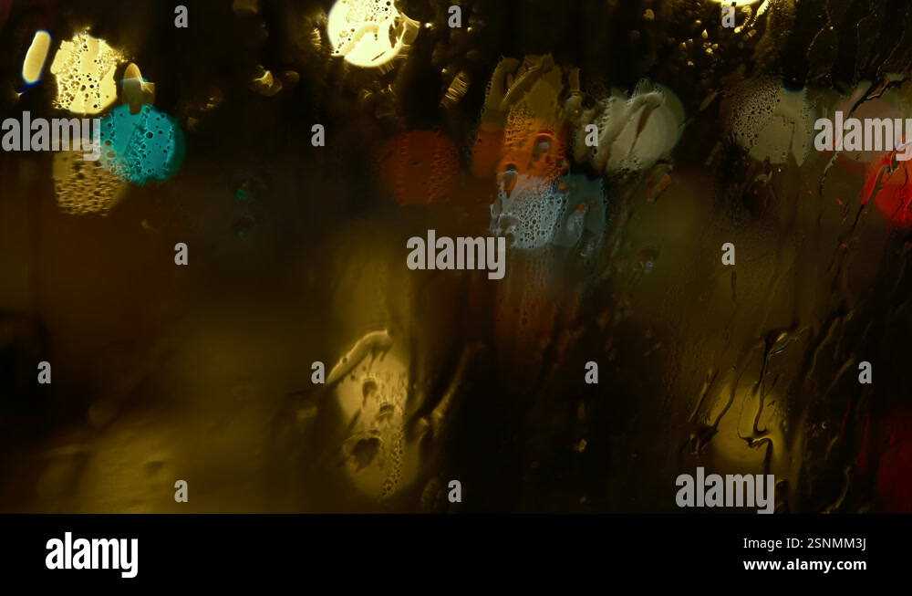 Wet window inside in car, defocused traffic jam on highway rainy night ...
