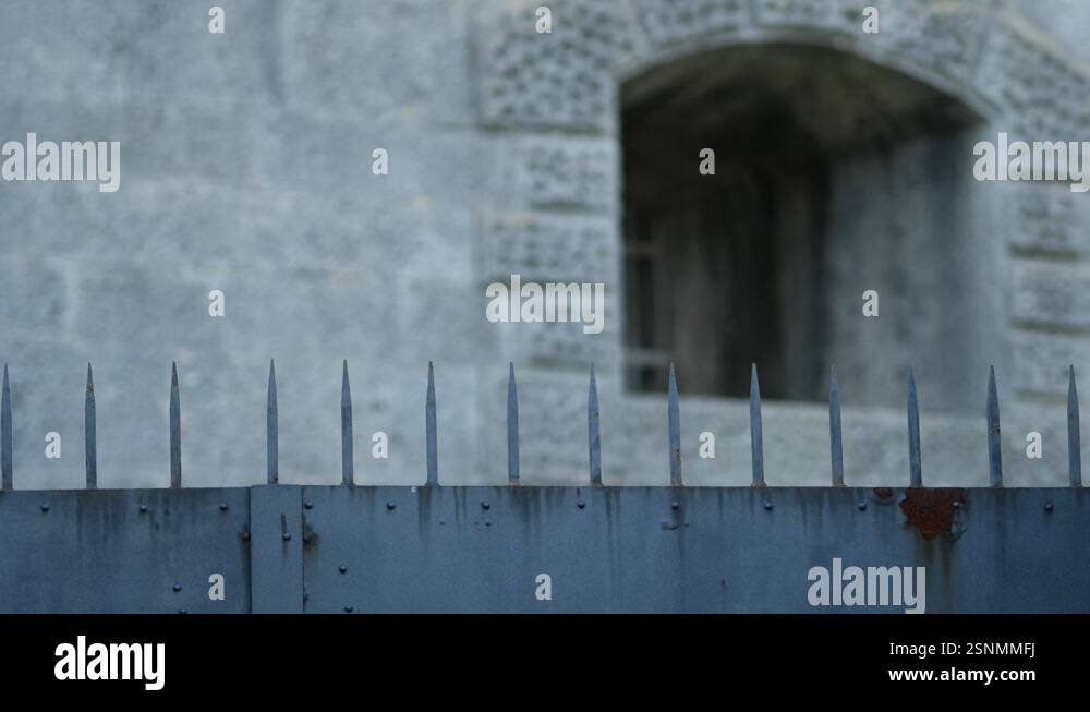 Massive iron gates with sharp spikes on top at abandoned military base ...