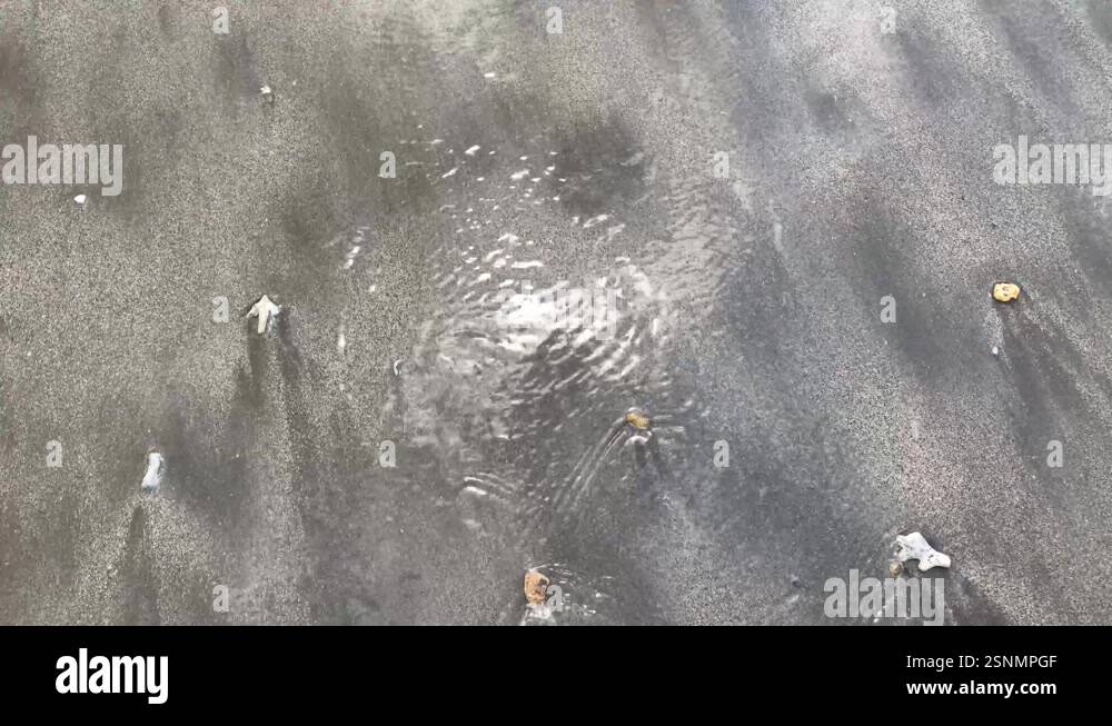 Close-up surface of beach waves flowing on gray sandy beach Stock Video ...