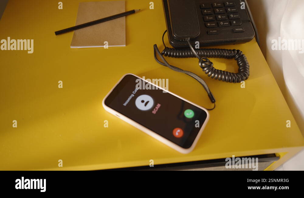 A close-up of a smartphone on a yellow nightstand shows an incoming ...