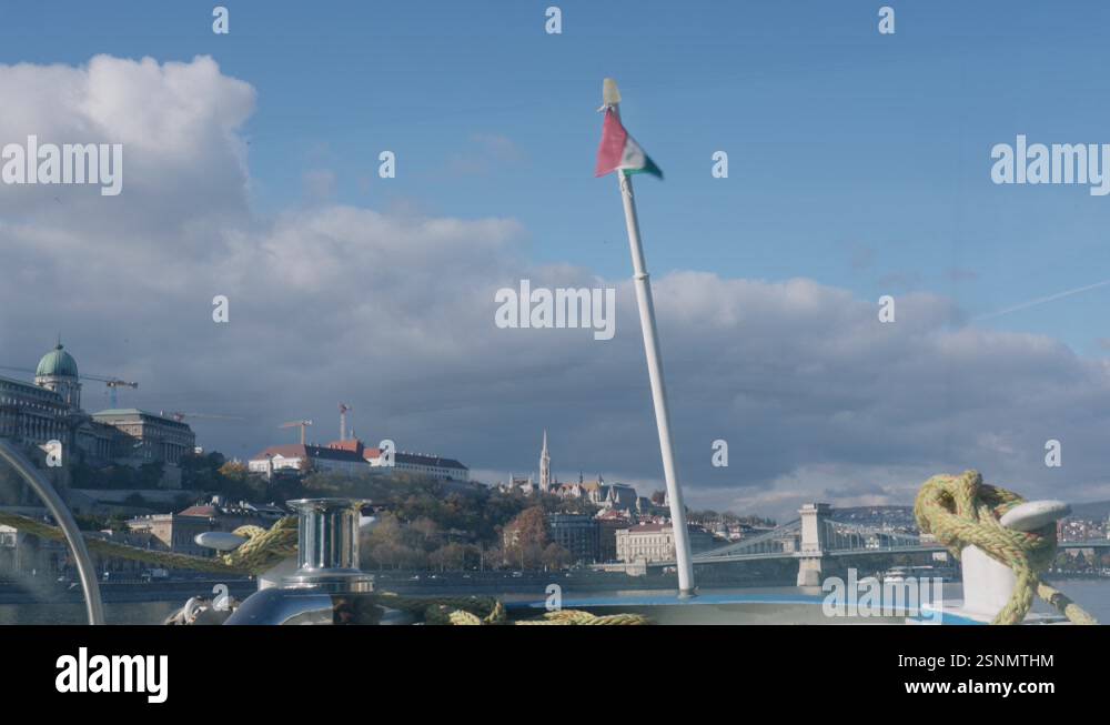 Handheld view from a tourist boat on the Danube River, Hungarian flag ...
