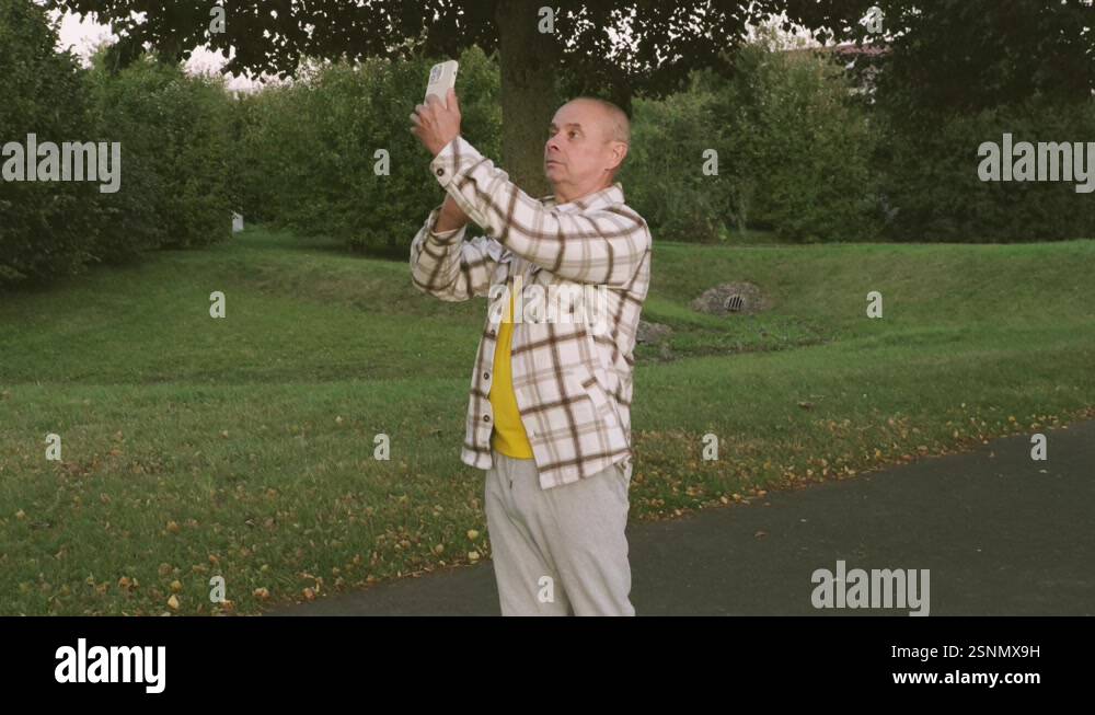 Positive elderly white man 65 years old enjoying technology, senior ...