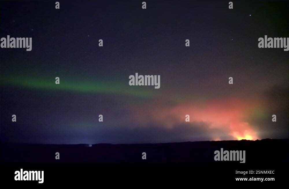 Panorama wide shot of erupting volcano at night. Northern lights and ...