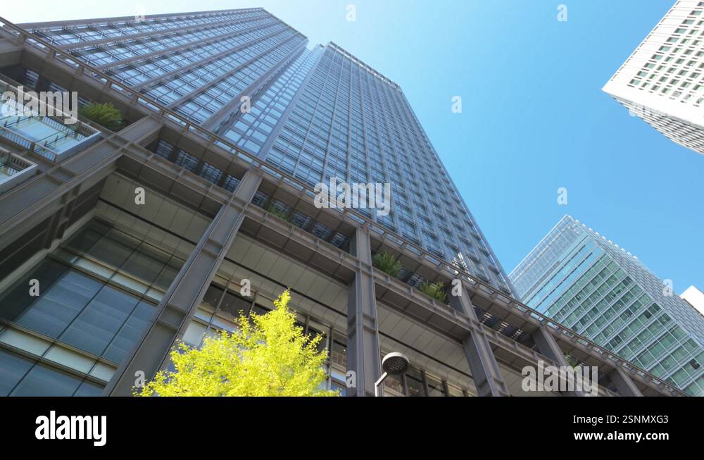 A striking upward perspective of sleek buildings around Marunouchi ...