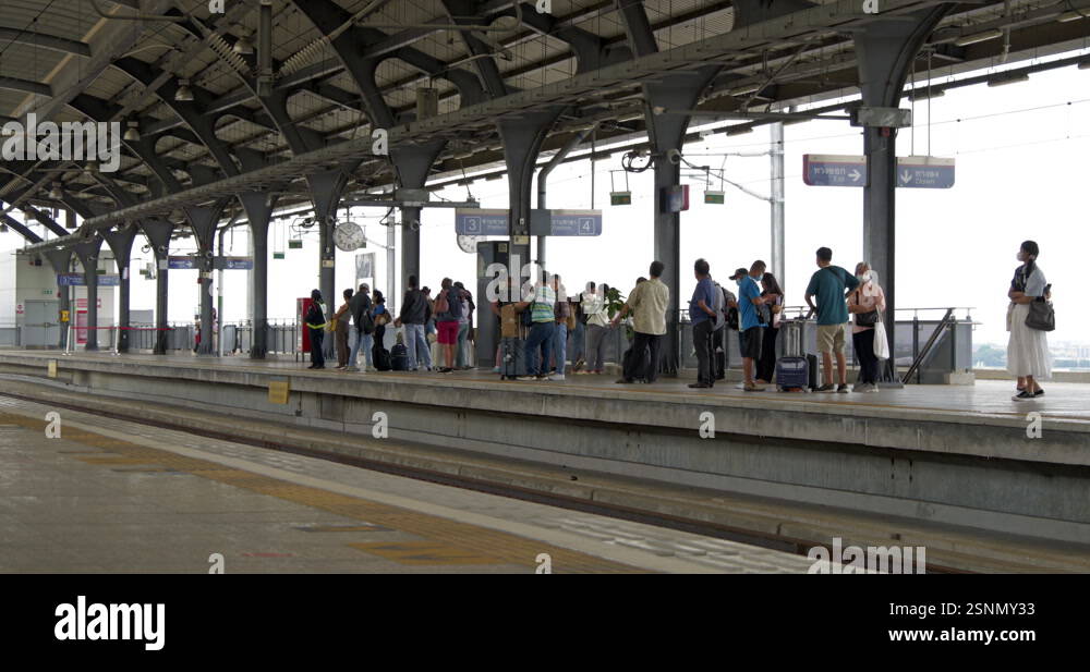 Travelers gather at the Red Line station after arriving at Don Mueang ...