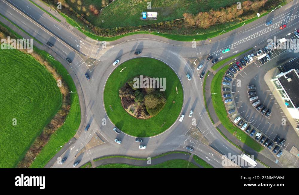 Drone looking down on roundabout in late winter with long shadows with ...