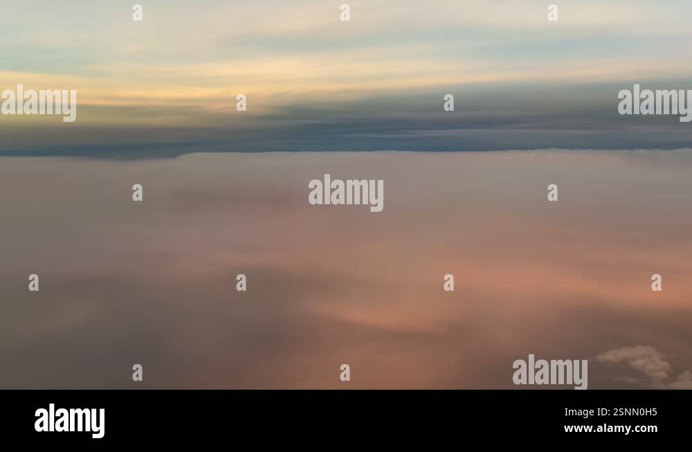 POV flying over a layer of golden color stratus clouds at sunrise as ...