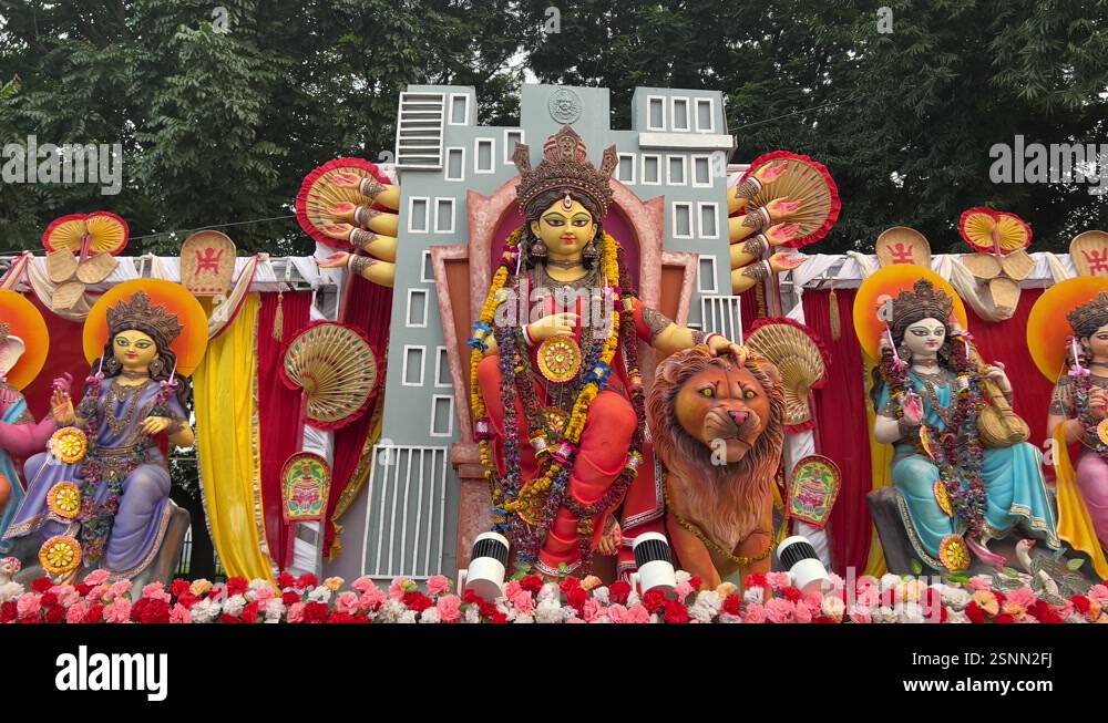 A pan shot of an idol of Maa Durga along with other gods and goddess on ...