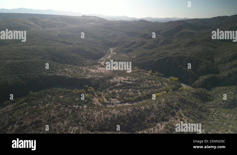 High aerial above desert terrain north of Phoenix Arizona with hills ...
