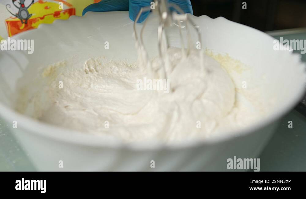 Mixing the batter thoroughly using an electric beater Stock Video ...