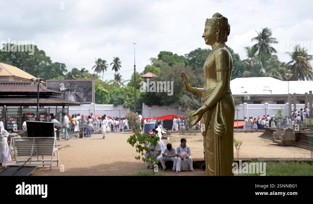 Golden buddha statue blessing pilgrims at ruwanweli maha seya temple ...