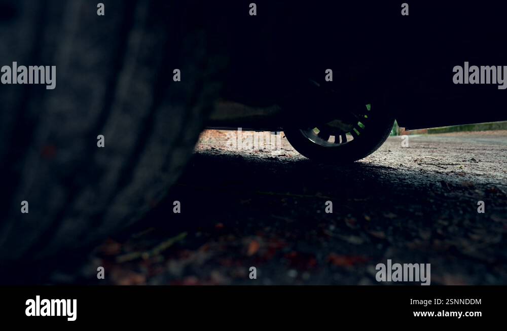 Close-Up Undercar View of a Wheel and Boots Walking Away Stock Video ...
