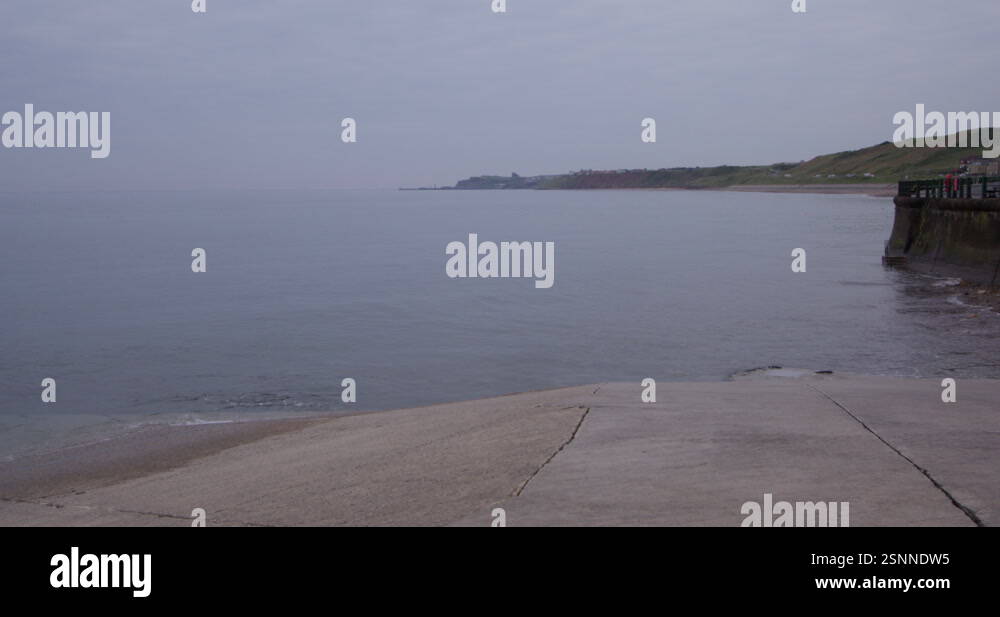 Wide shot looking south of sandsend wyke bay with boat slipway in ...
