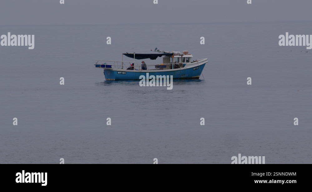 fisherman working on a small fishing boat at sandsend, whitby Stock ...