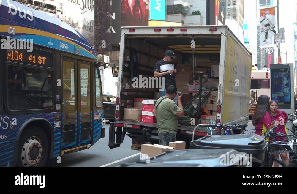 Workers Unloading a Delivery Truck on a Busy Street in Times Square ...