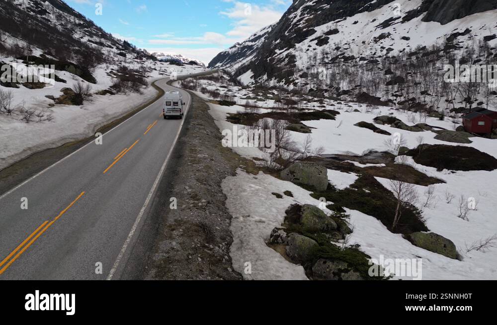 Witness the breathtaking scene as a lone van navigates the winding ...