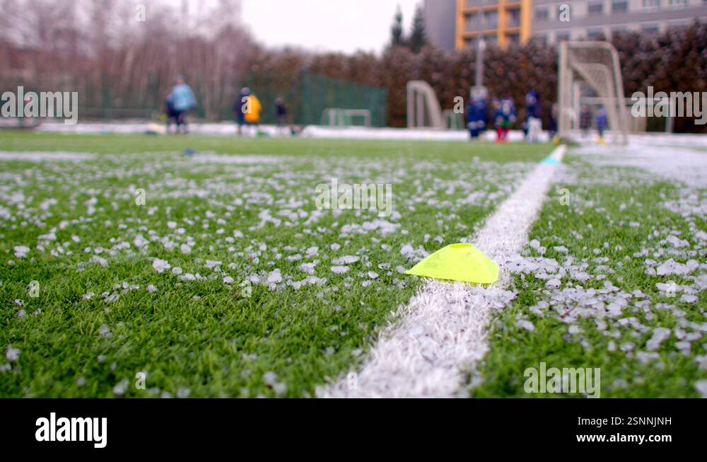 A training session on a snowy football field with players and marked ...