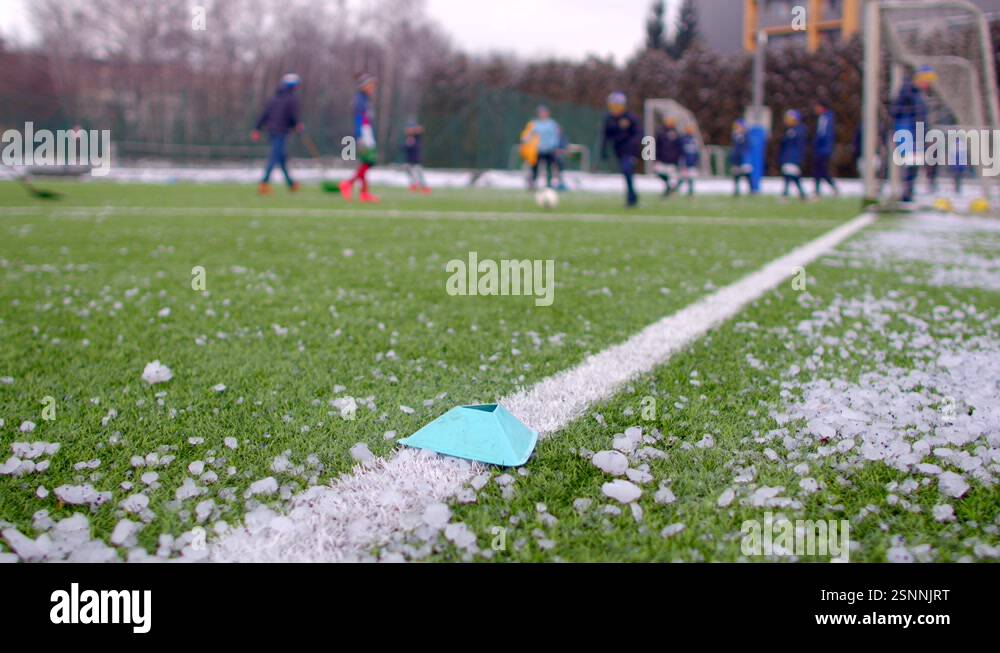 A training session on a snowy football field with players and marked ...