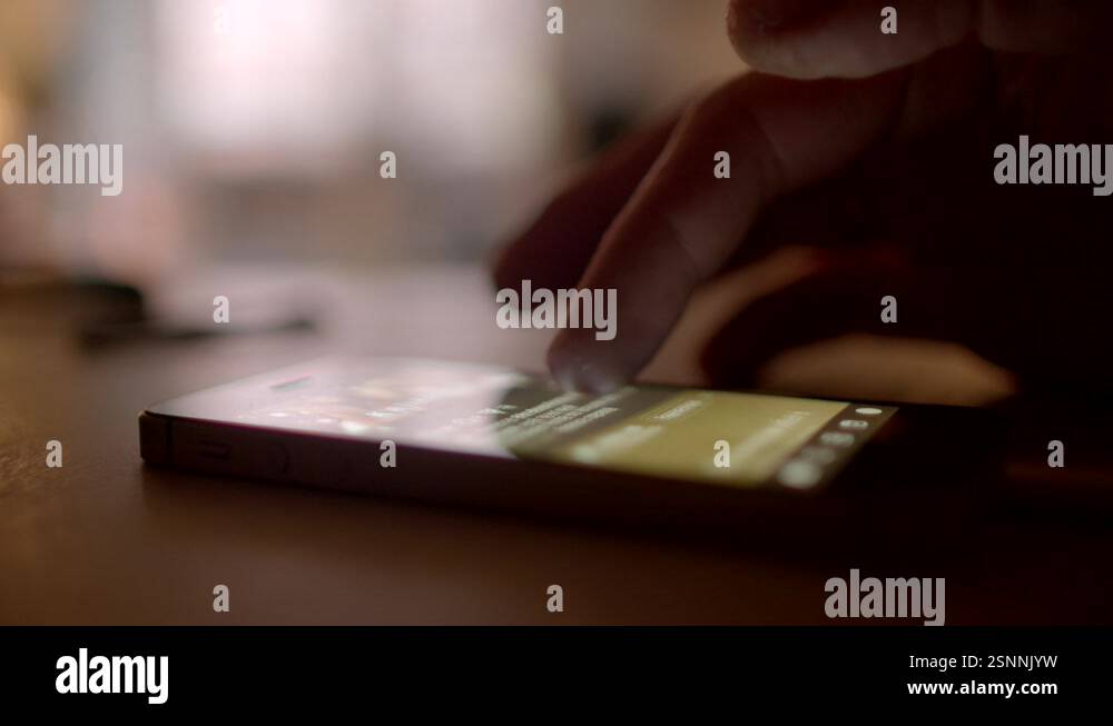 A sleek smartphone is resting on the table, displaying various ...