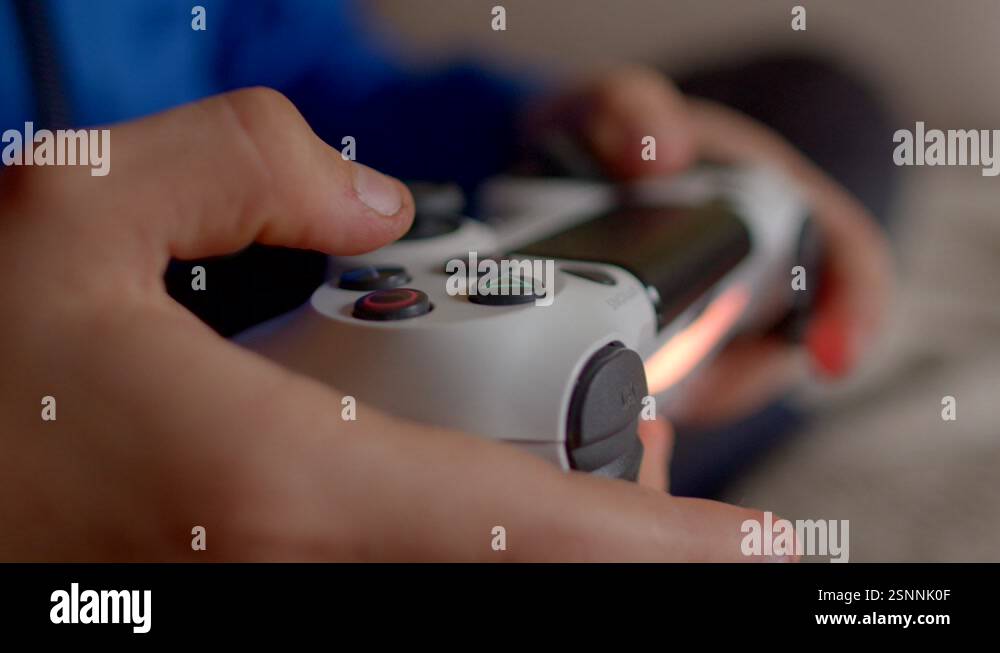 control a video game hero player grips a controller tightly against a blurred ba Stock Video ...
