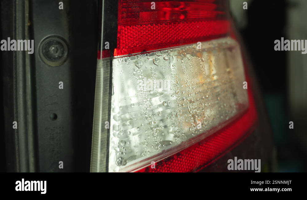 Close up of a right back light of a car, vehicle, condensation drops ...