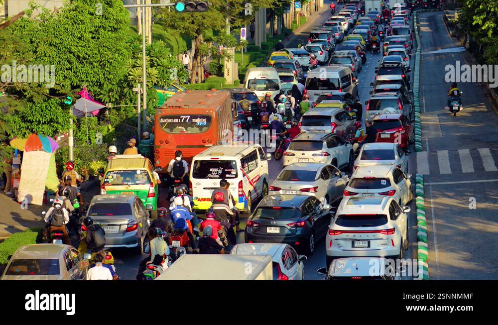 Traffic moves slowly along a busy road cowded traffic jam road in city ...