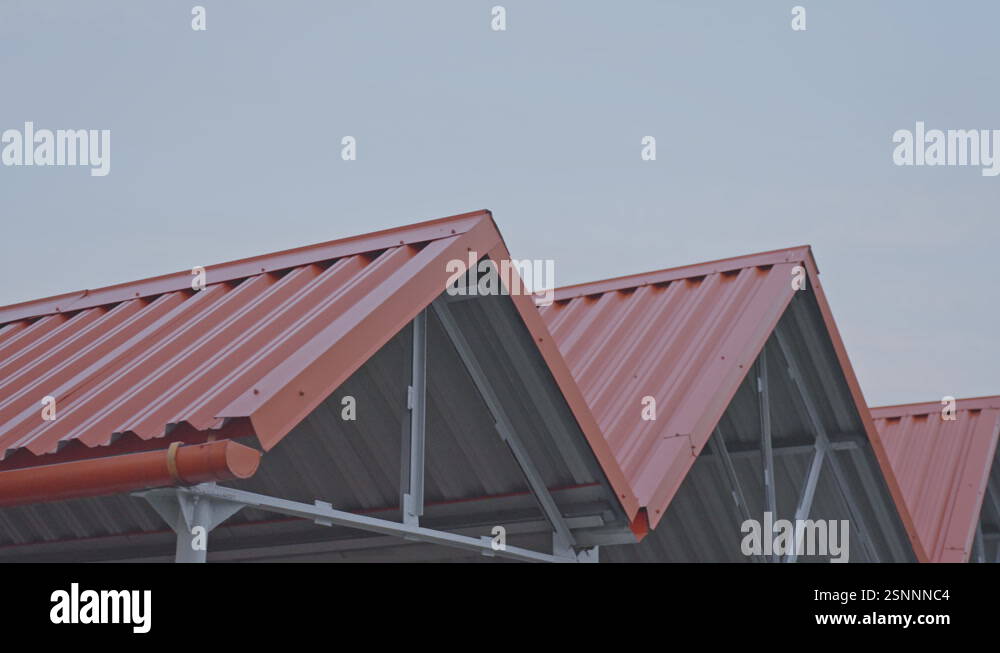 Vivid red corrugated metal roofing with structural gutters Stock Video ...