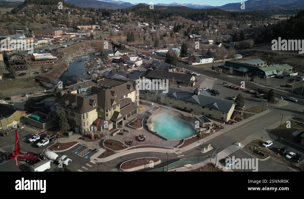 Low aerial above Pagosa Hot Springs resort thermal pools in Colorado ...