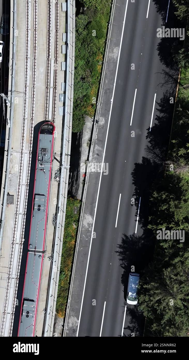 Vertical aerial perspective of an intercity train approaching Santa Fe ...