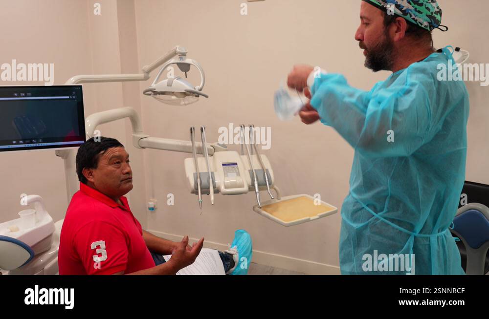 Dentist explaining to his patient post-op tips at the clinic Stock ...