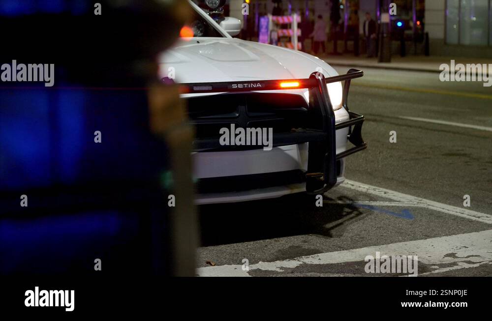 Anamorphic shot of a police car creating a roadblock with flashing ...