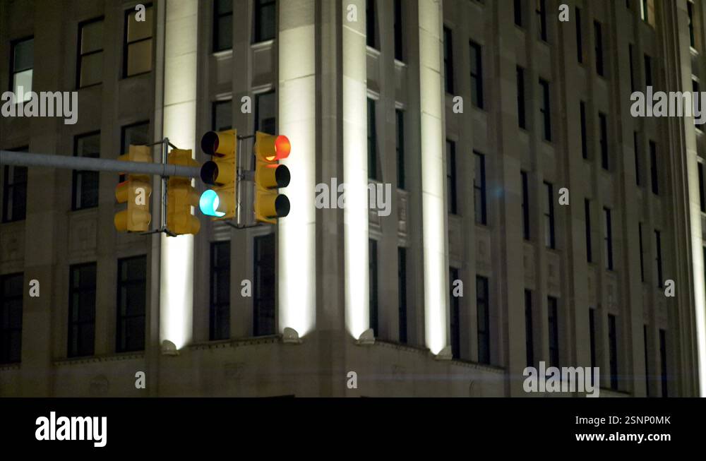 Static anamorphic shot of traffic lights changing from red to green in ...