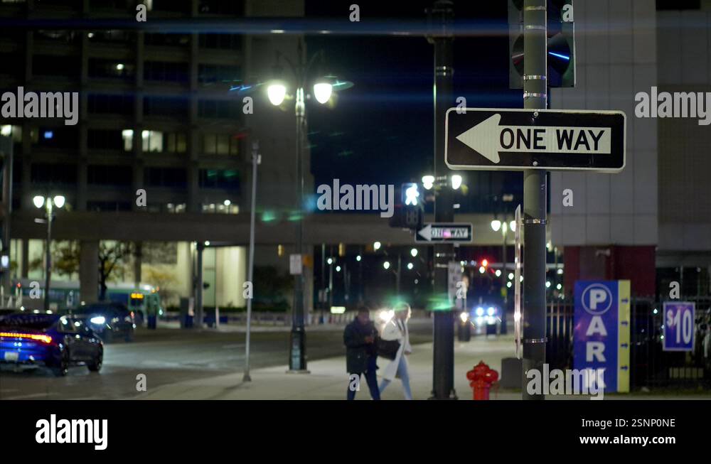 static shot of one way signs in downtown Detroit with pedestrians ...