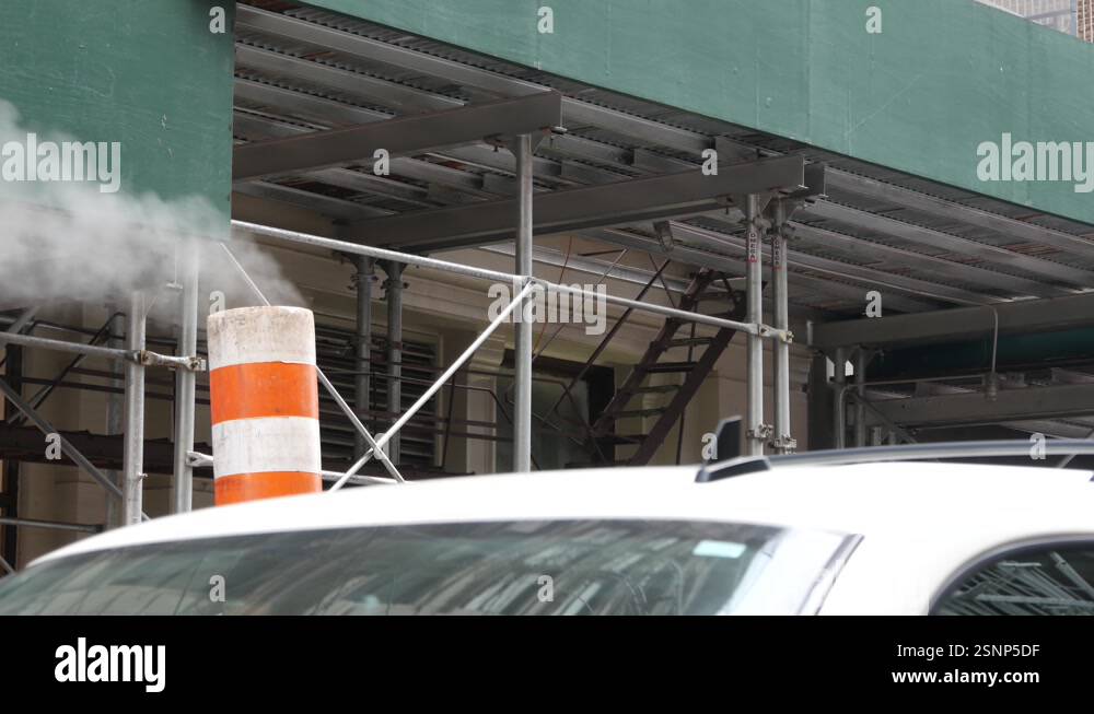 Steam vapor vented, New York City street steam system, orange vapour ...