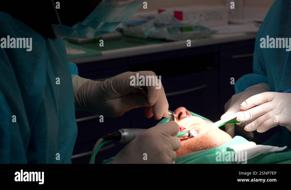 Dental doctor working with a dental implant in a modern clinic ...